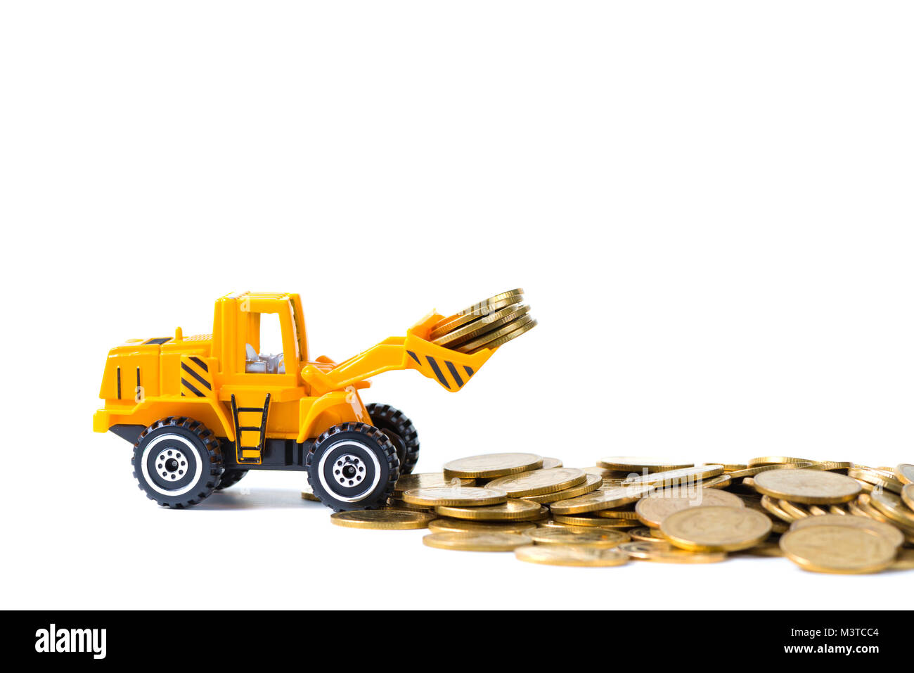 Mini bulldozer truck loading stack coin with pile of gold coin ...
