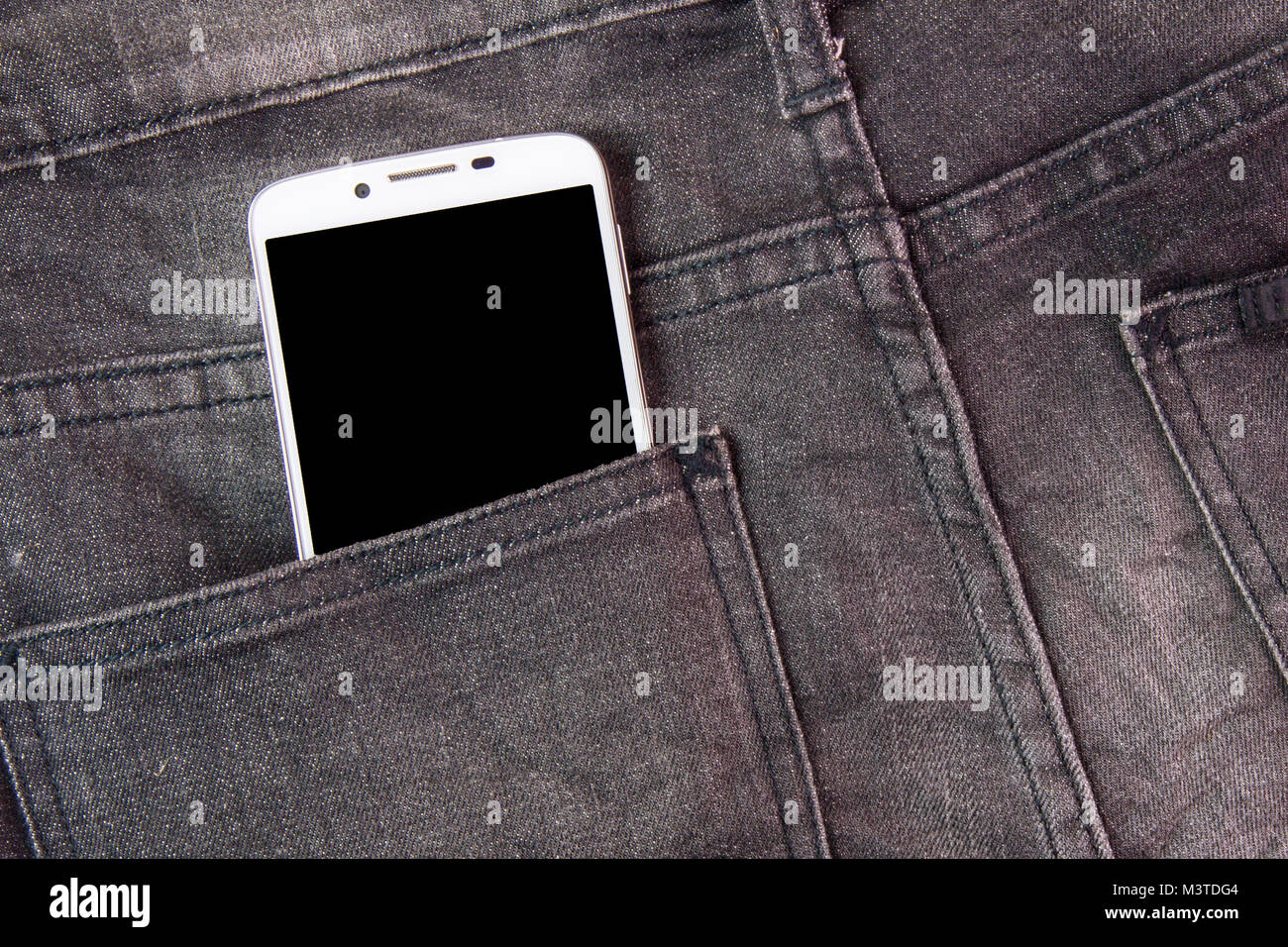 Mobile phone in pocket jeans with black screen. jeans Background Stock ...