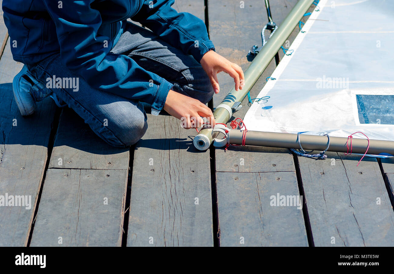 aspiring sailor prepares the sail of his boat the sailing course Stock ...