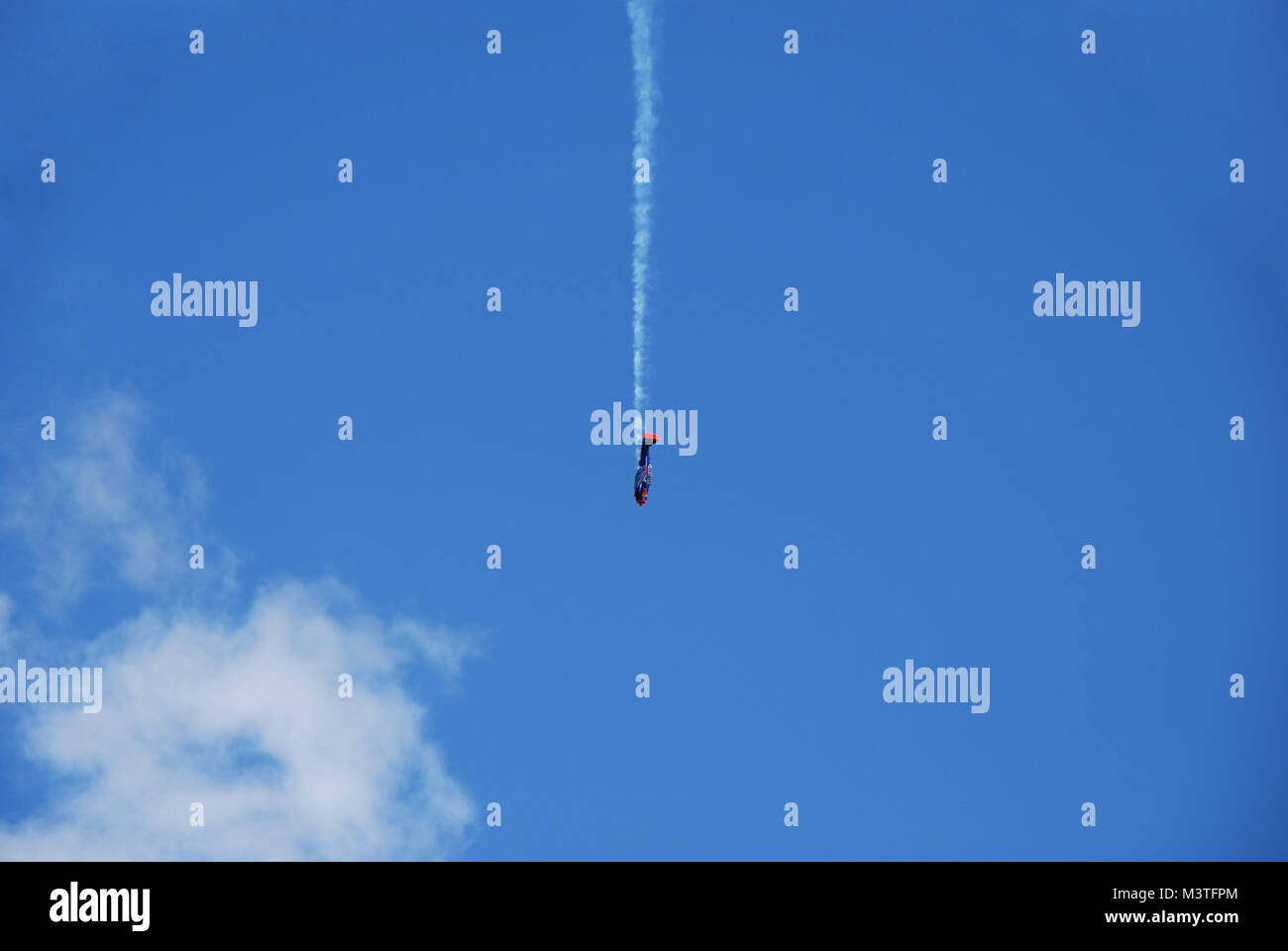 red blue airplane flies fast and straight down at a flight show Stock ...