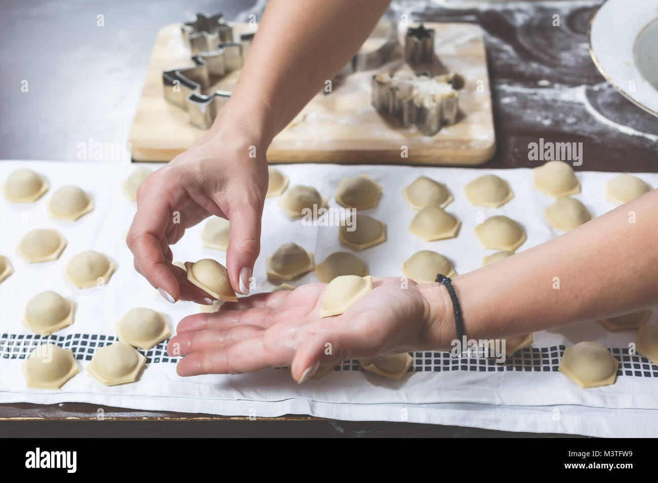 The process of making delicious homemade dumplings. Female hands is ...