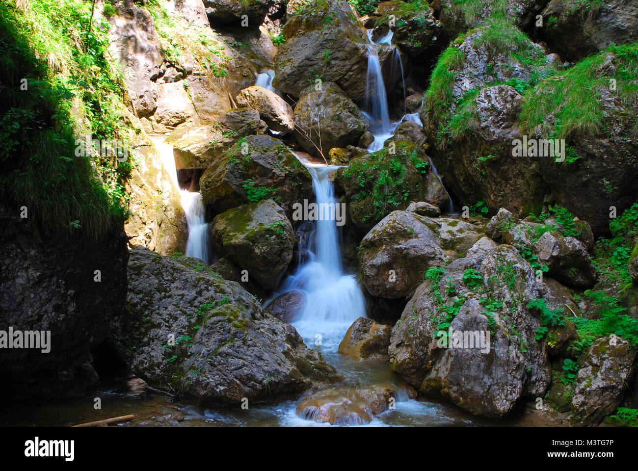 beautiful clear waterfall in between many large rock mountain Stock ...