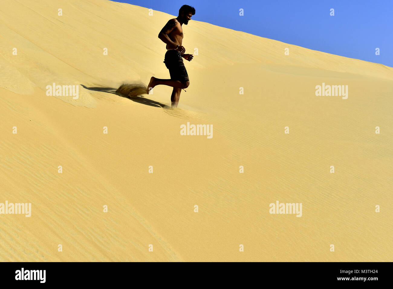 Young man jogging on desert hi-res stock photography and images - Alamy