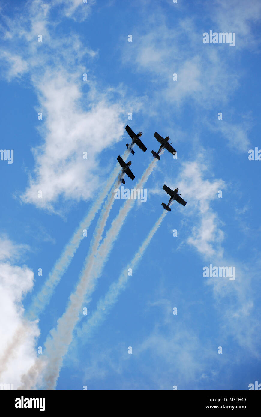 four planes fly fast and steeply upward at a flight show Stock Photo ...
