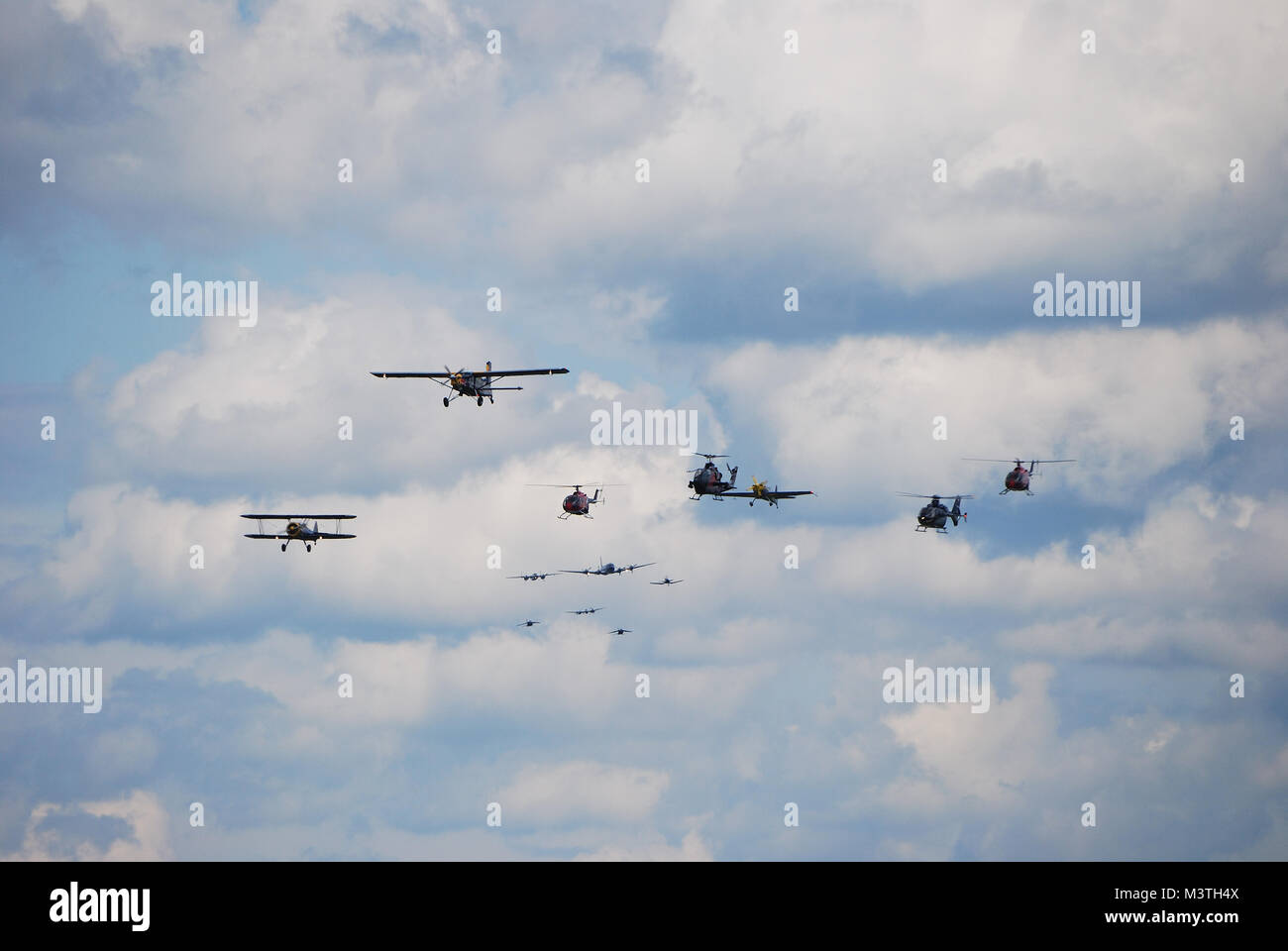 many different aircraft and helicopters flying at a flight show Stock ...