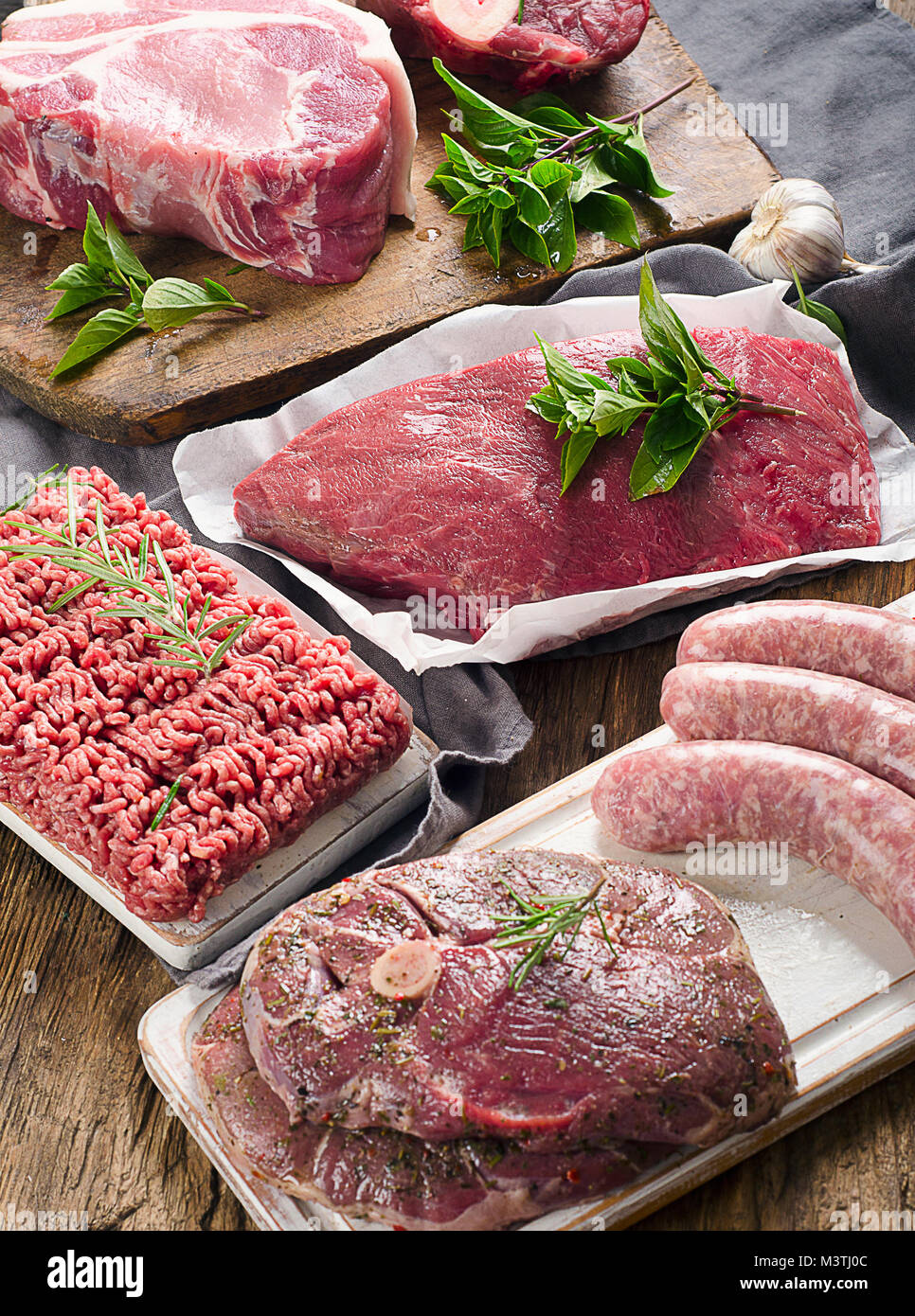 Different types of fresh raw meat on dark wooden background. Top view ...