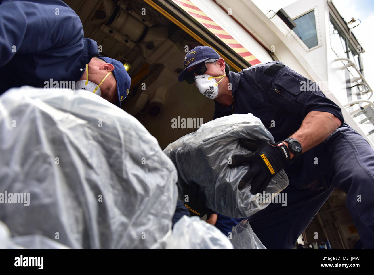 Coast Guard Cutter Waesche crewmembers offload seized cocaine from the ...