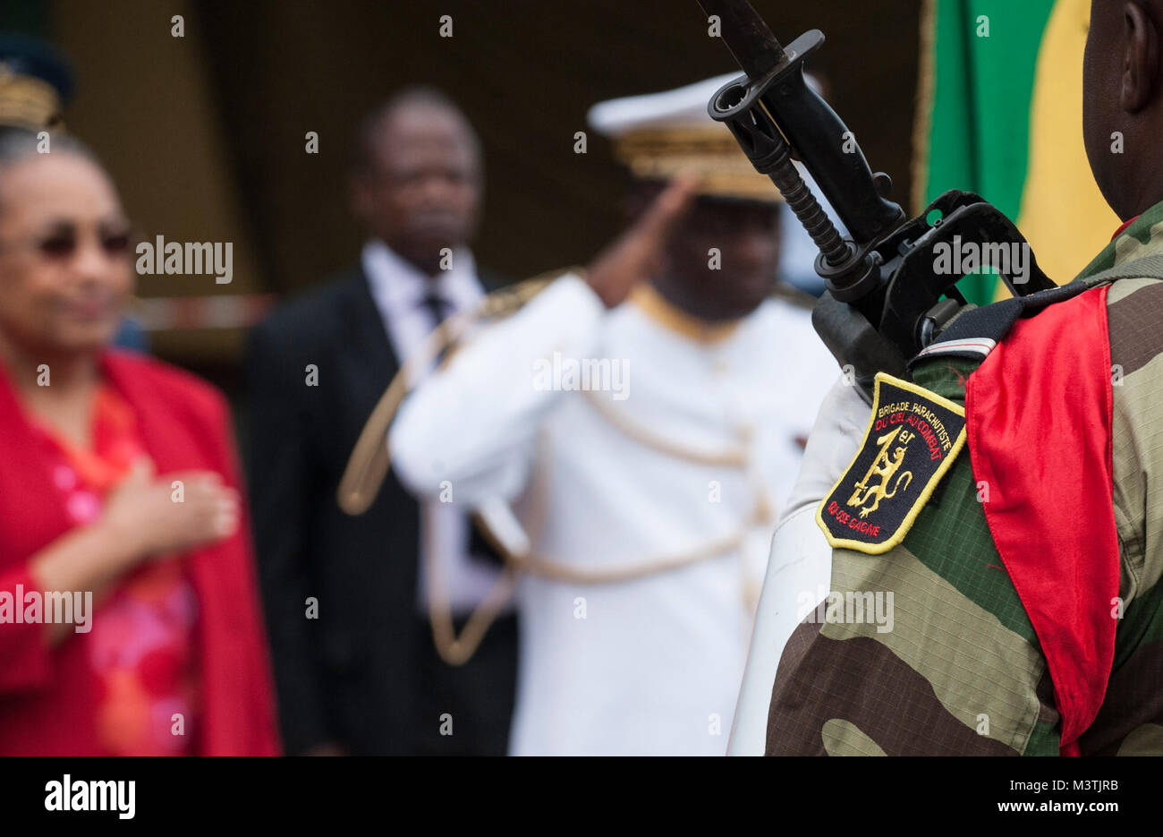 Distinguished visitors and members of the Gabonese Armed Forces stand ...