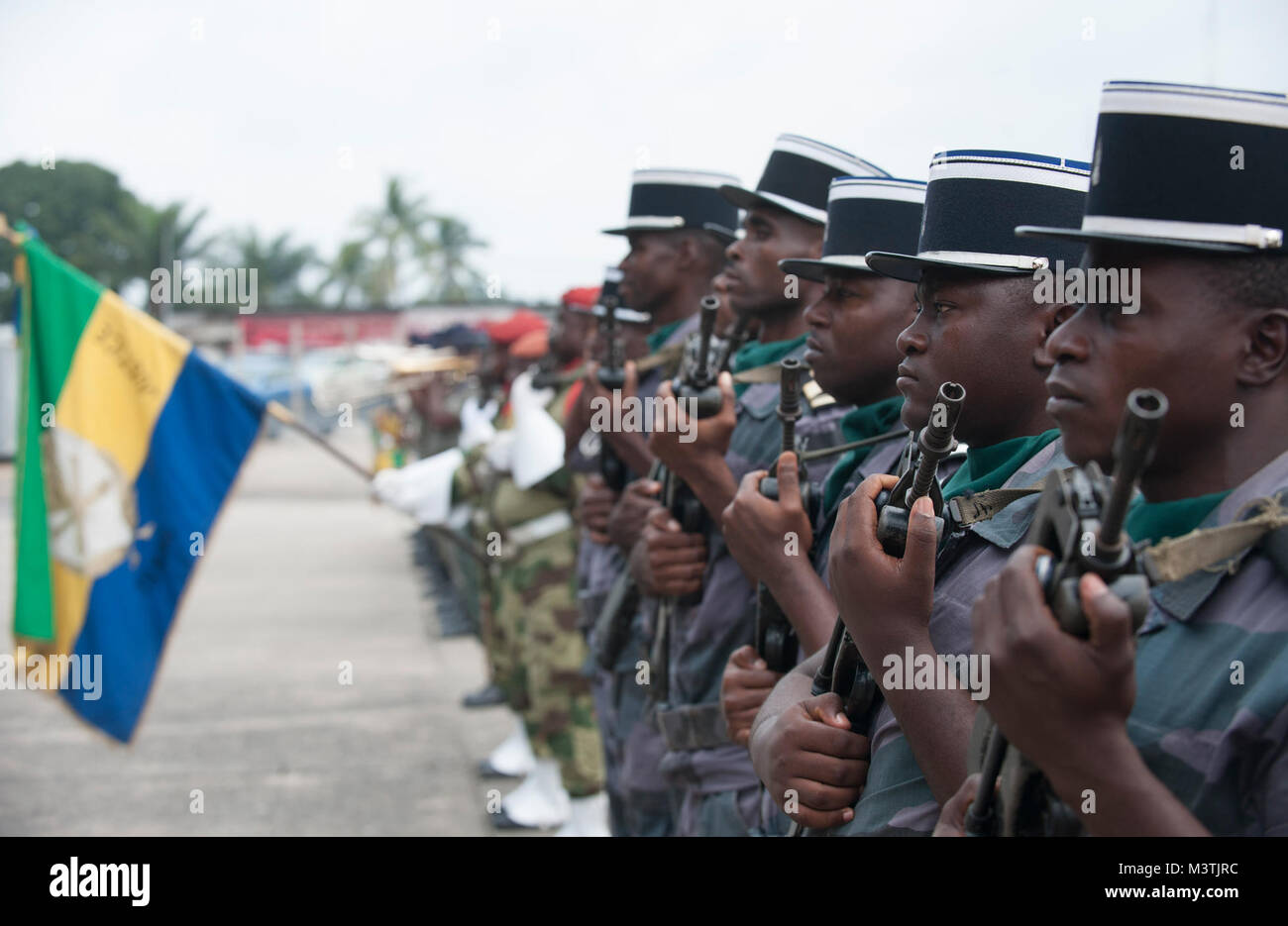 Military members from the Gabonese Armed Forces stand in formation ...