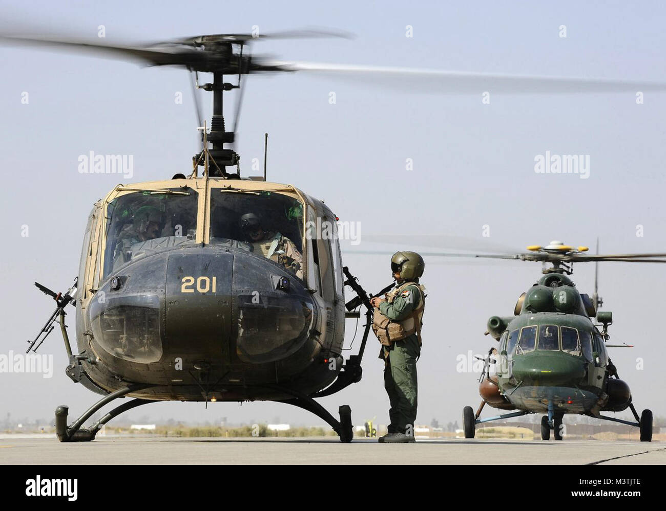 An Iraqi UH-1H and an Iraqi Mi-17 Hip helicopter prepare to transport a ...
