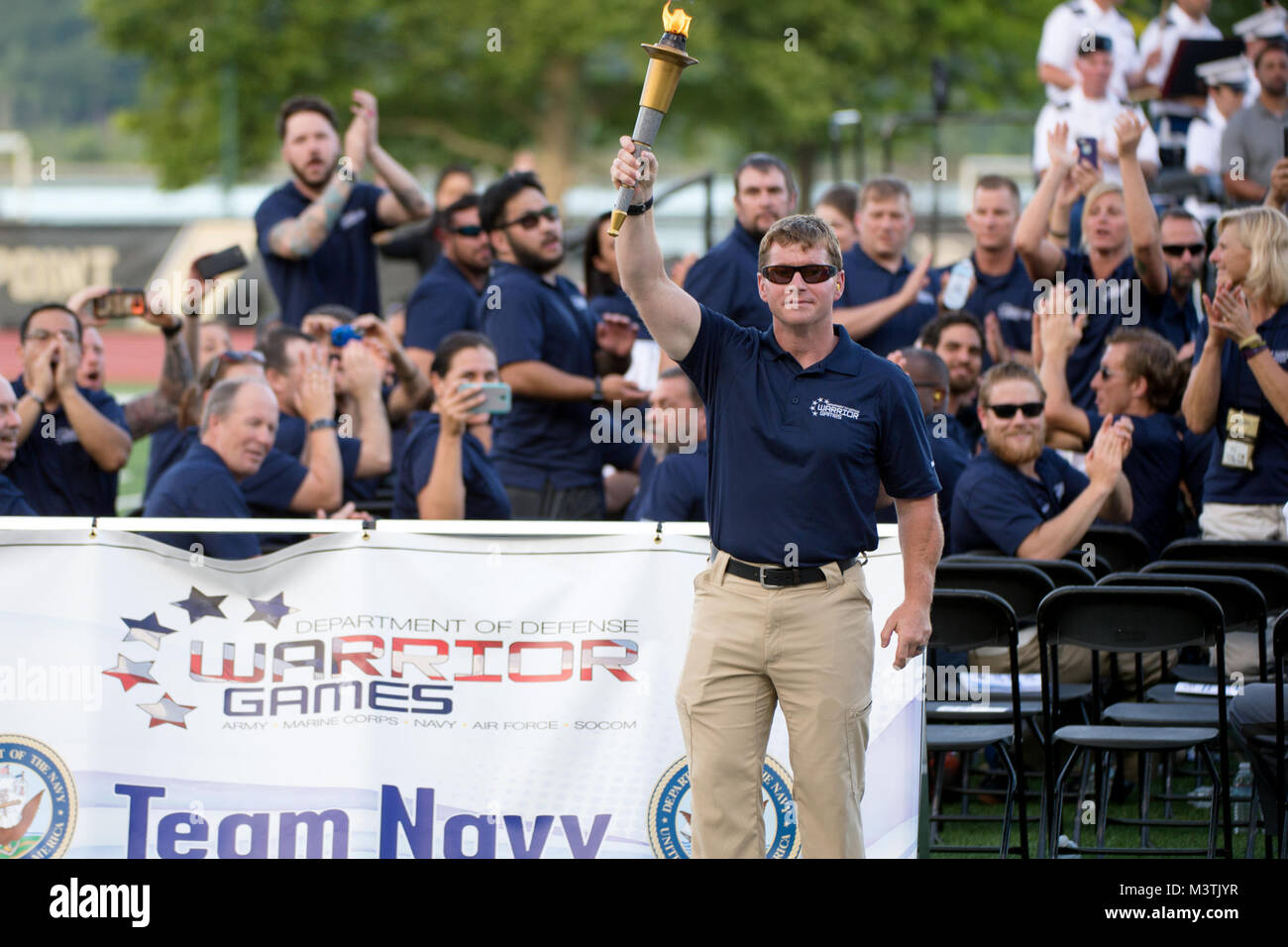 Chief Petty Officer Ron Condrey holds high the 2016 Department of ...