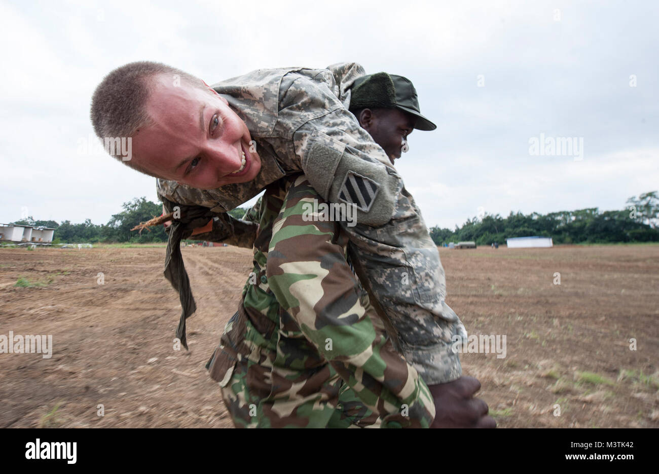 A Gabonese Armed Force’s Soldier carries an U.S. Army SPC. Ridgely, an ...