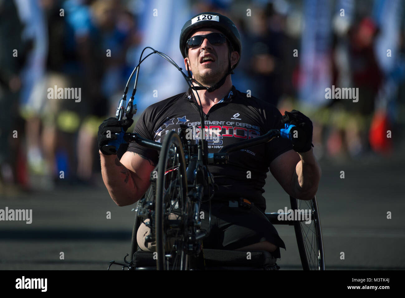 Army veteran Staff Sgt. Timothy Payne powers a hand cycle across the ...