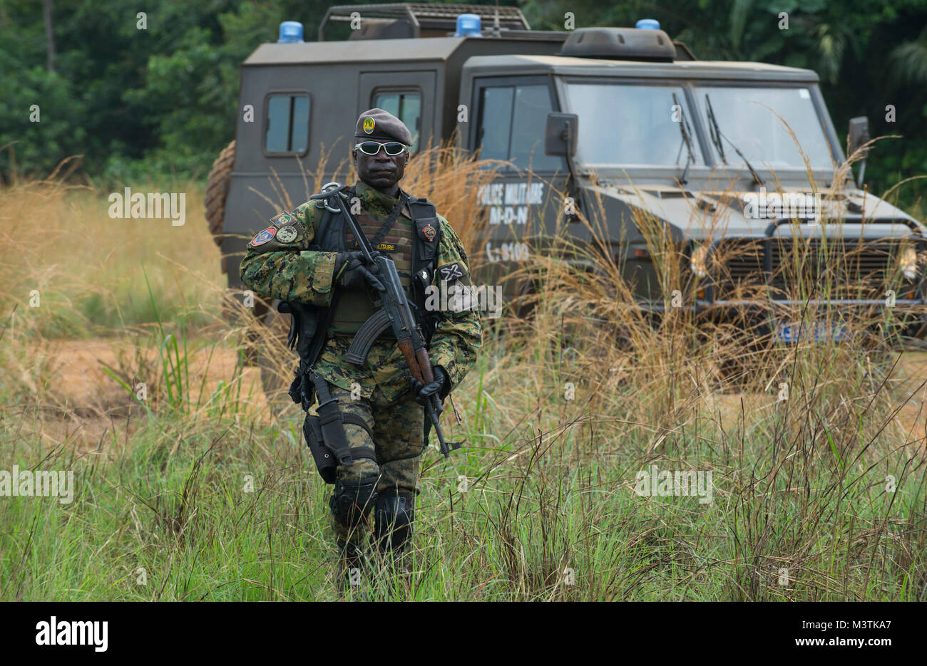 A member of the Gabonese Military Police provides security for several ...