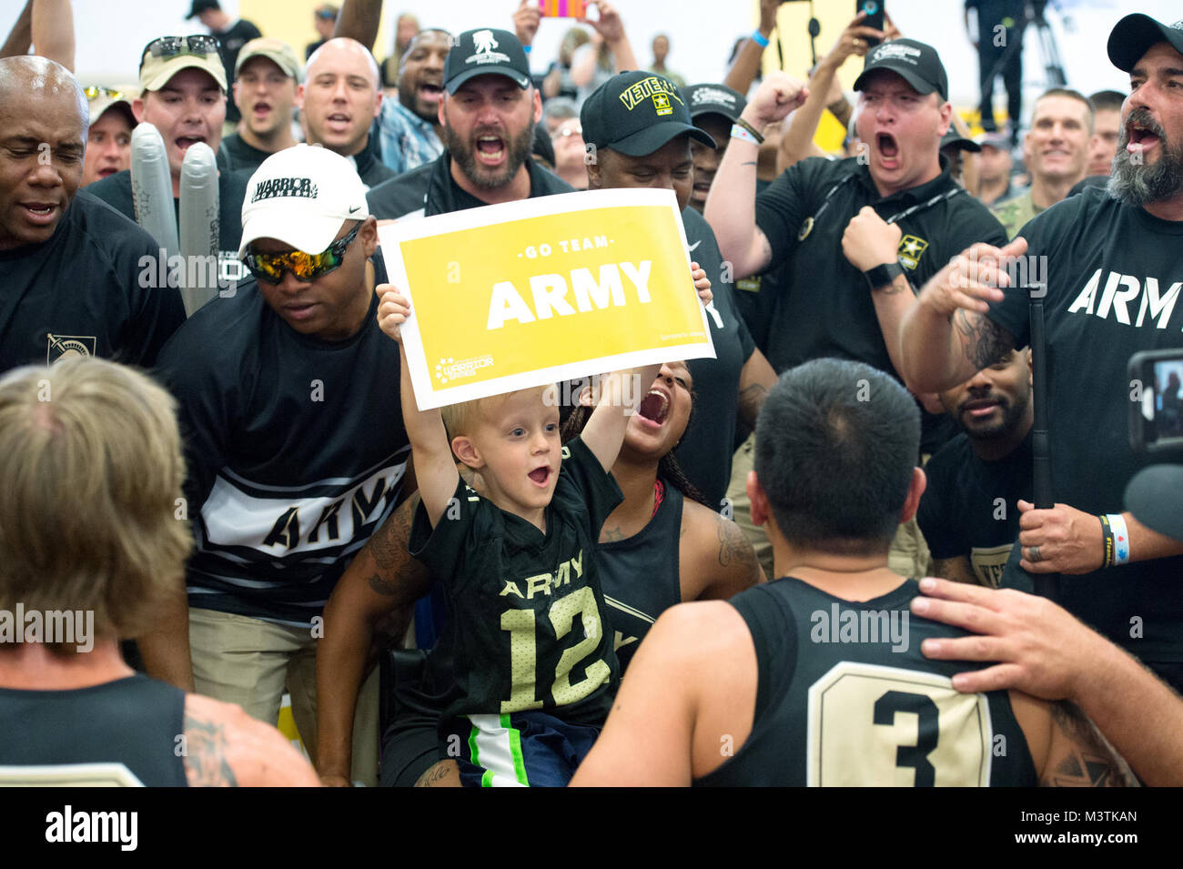 Timothy Berg, 5, helps Army celebrate a gold medal in basketball during ...
