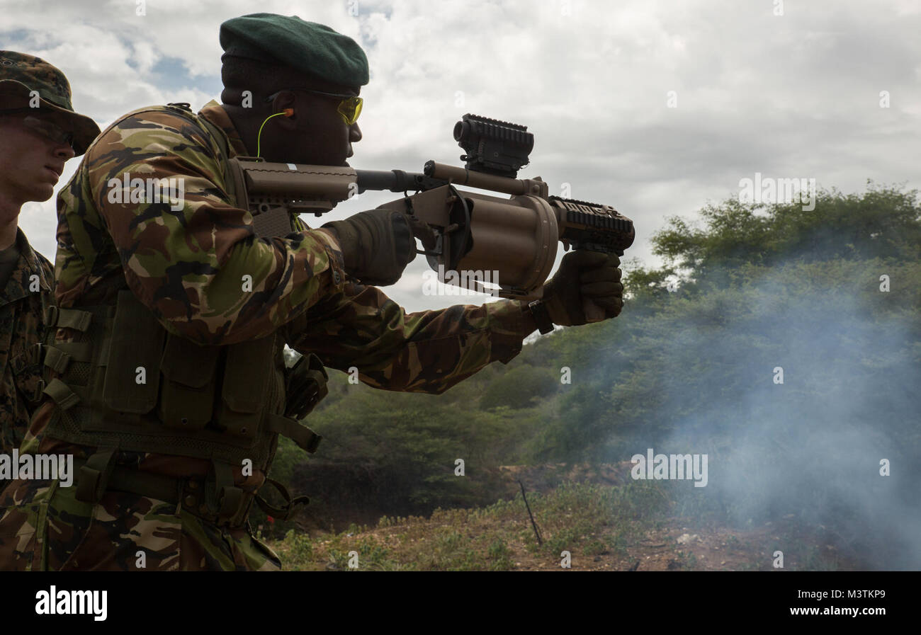 A service member from Barbados shoots non-lethal rounds with an M32 ...