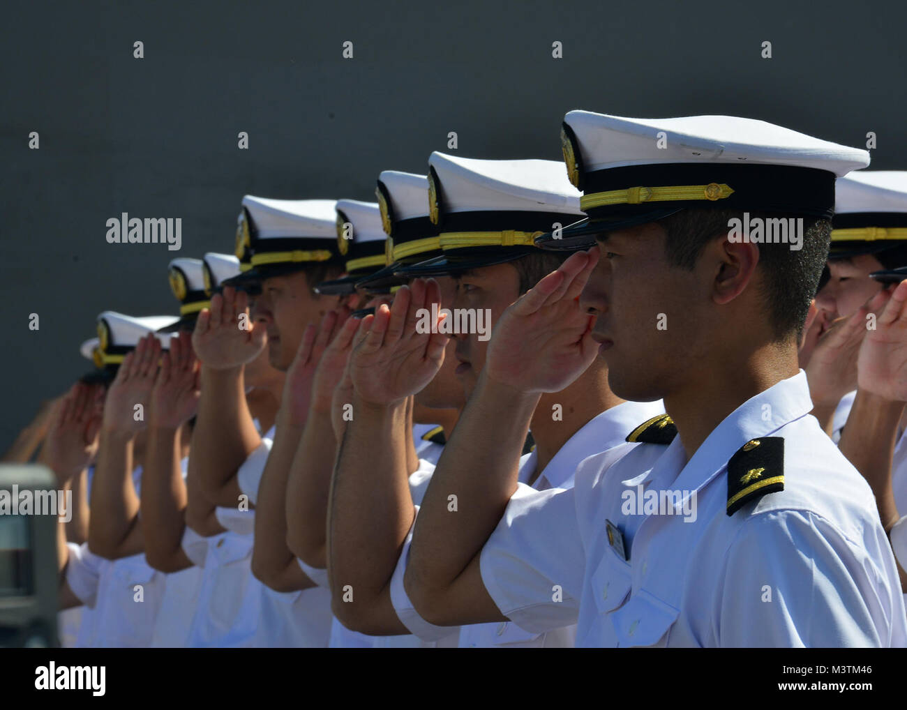 Newly commissioned Japanese ensigns salute during morning colors prior ...