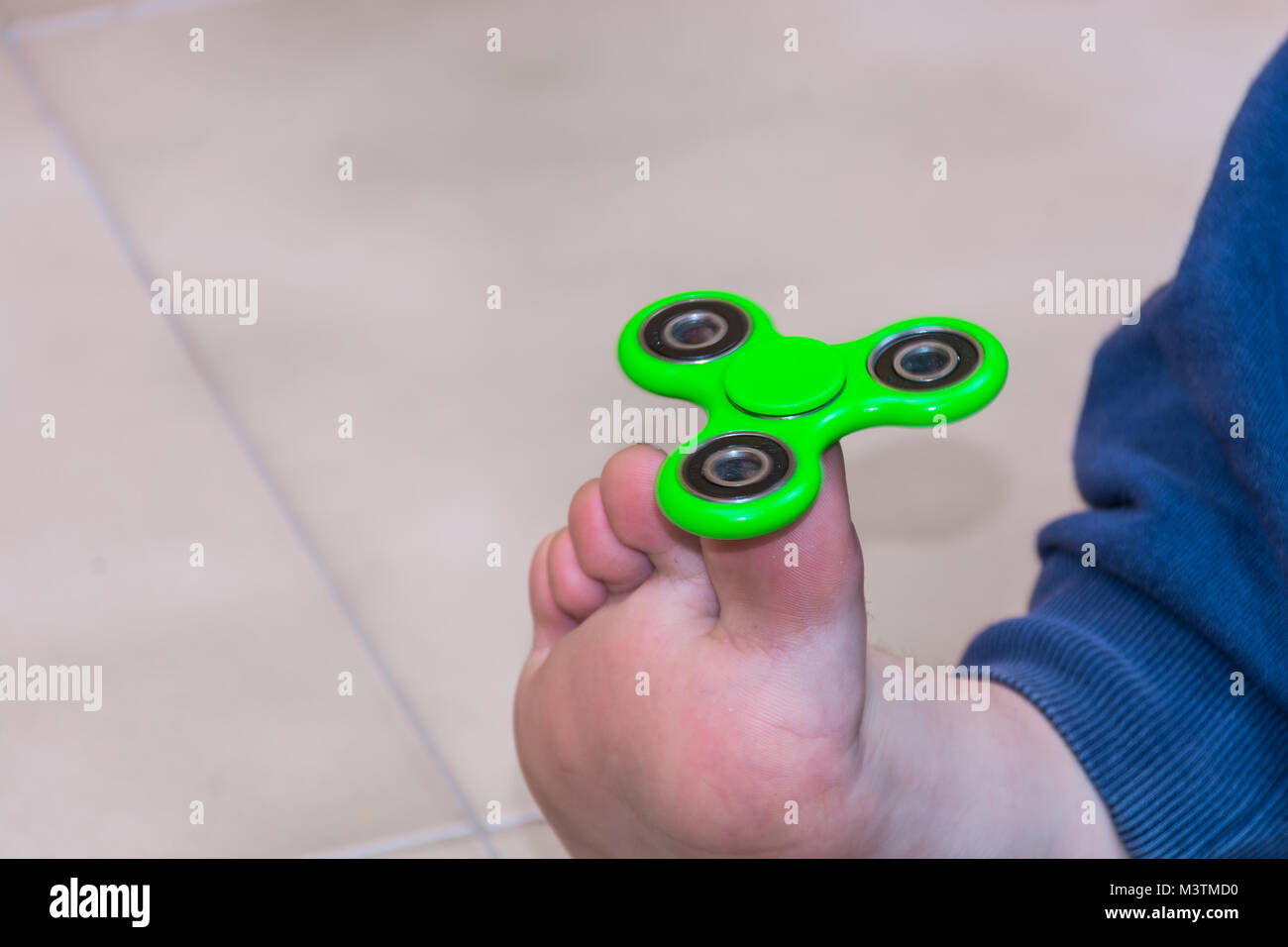Boy playing with fidget spinner gadget. The fidget spinner is a toy, a ...