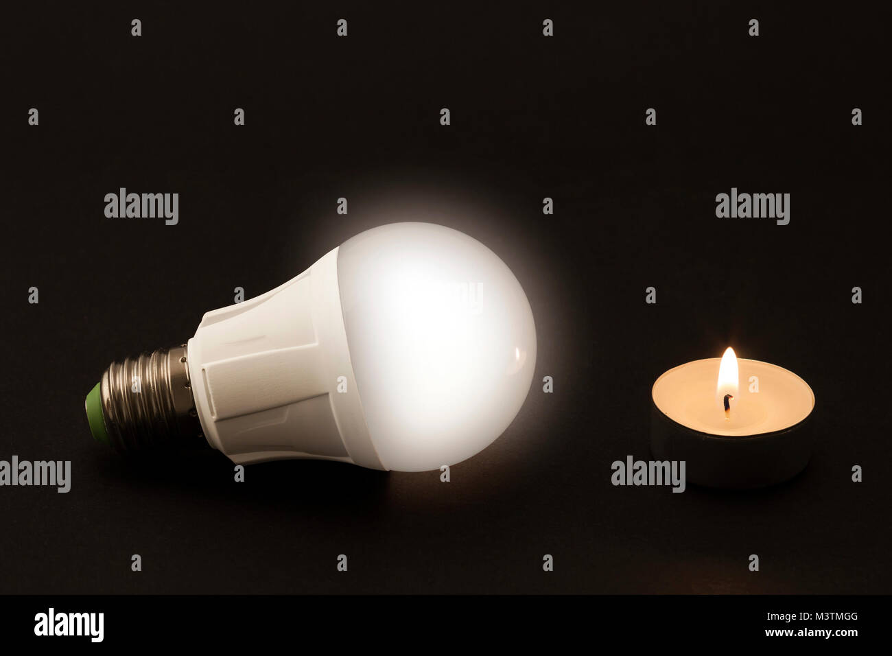 Progress of lighting displayed with candle and LED bulb. Evolution of ...