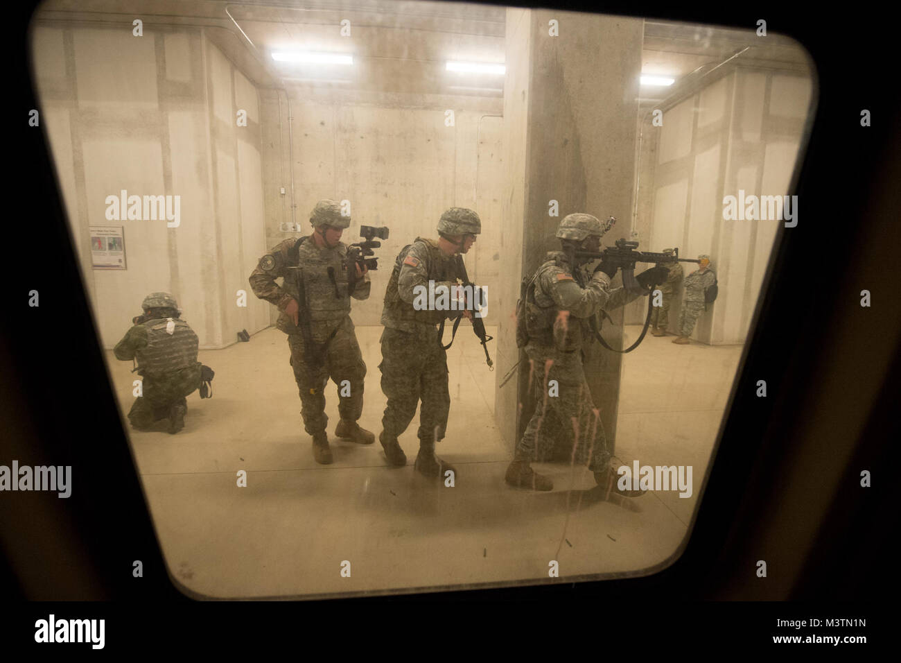 Combat camera photographers move with soldiers through a subway station ...