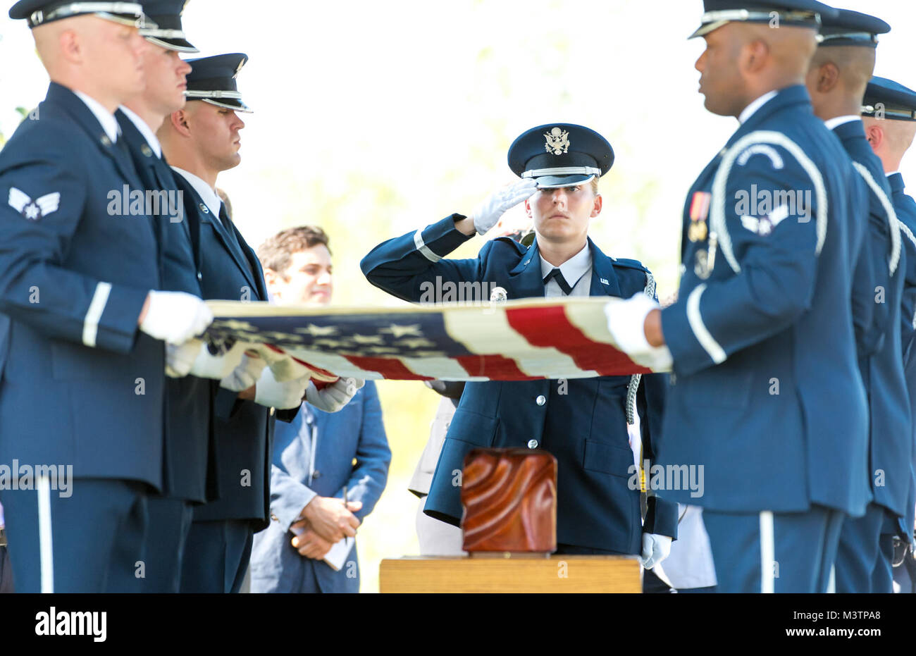 Leader of a U.S. Air Force Honor Guard, Capt. Jennifer Lee, salutes the ...