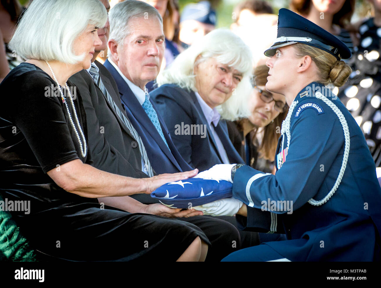 Leader of a U.S. Air Force Honor Guard, Capt. Jennifer Lee, presents a ...