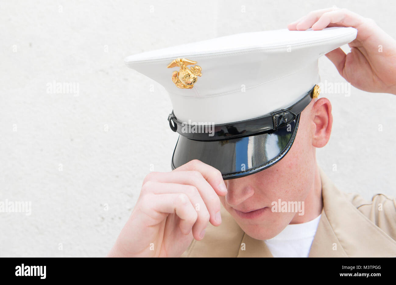 U.S. Marine Sgt. Dakota Smith, a Marine Security Guard, adjusts his cap ...