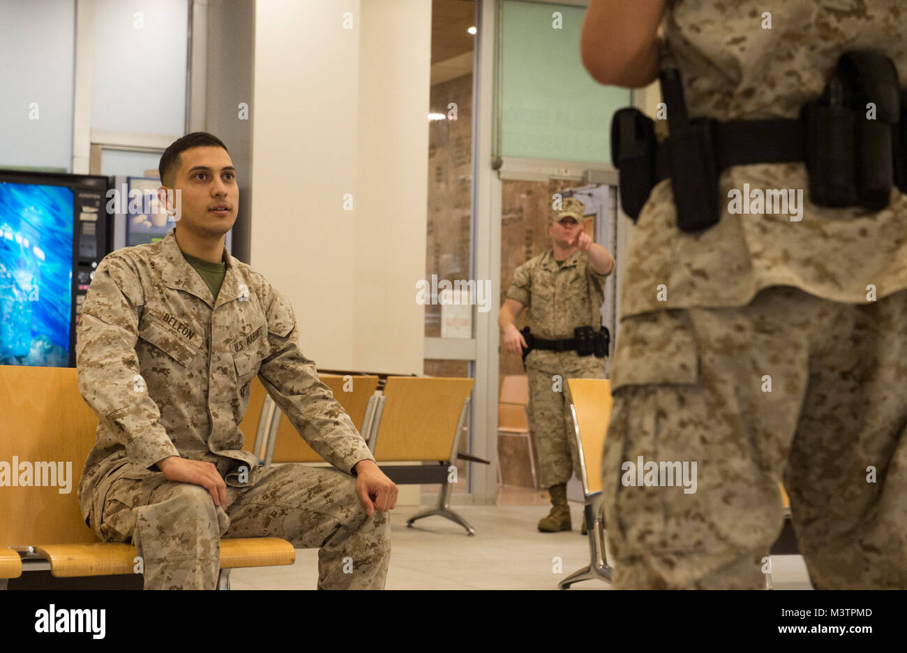U.S. Marine Sgt. Juan Deleon (left), a Marine Security Guard, simulates ...