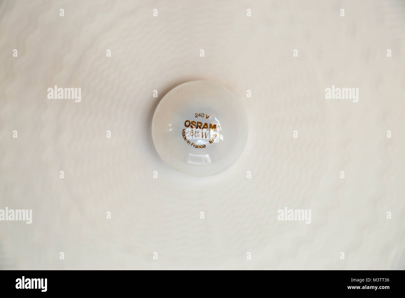 An Osram traditional tungsten 60W watt light bulb pictured hanging from ...
