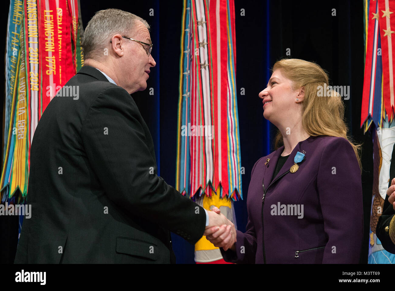 Deputy Defense Secretary Bob Work, left, congratulates Dr. Mary Ann ...