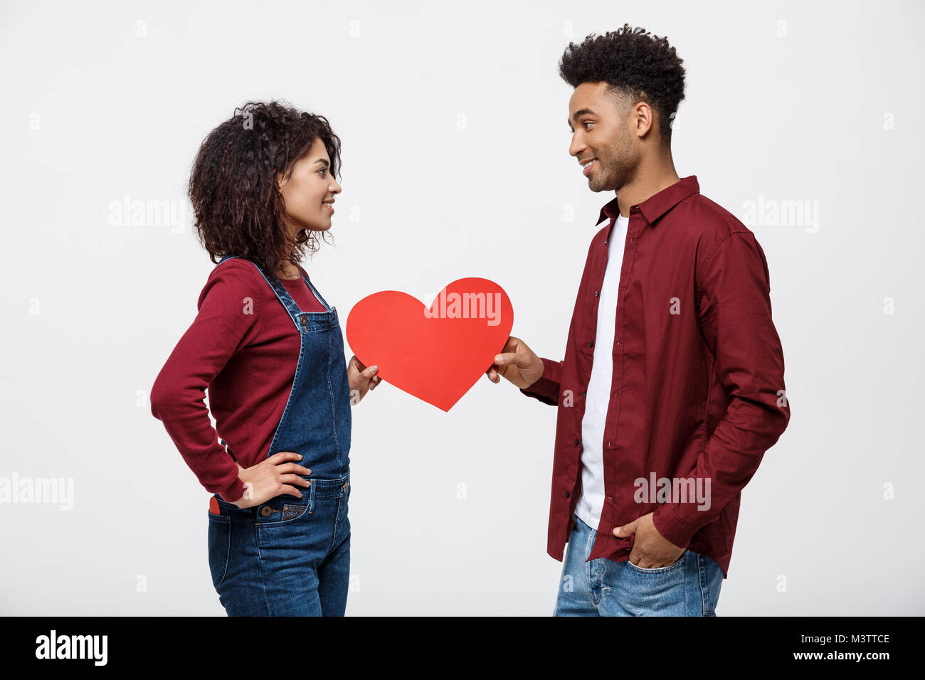 Young happy african american couple in love holding red paper heart ...