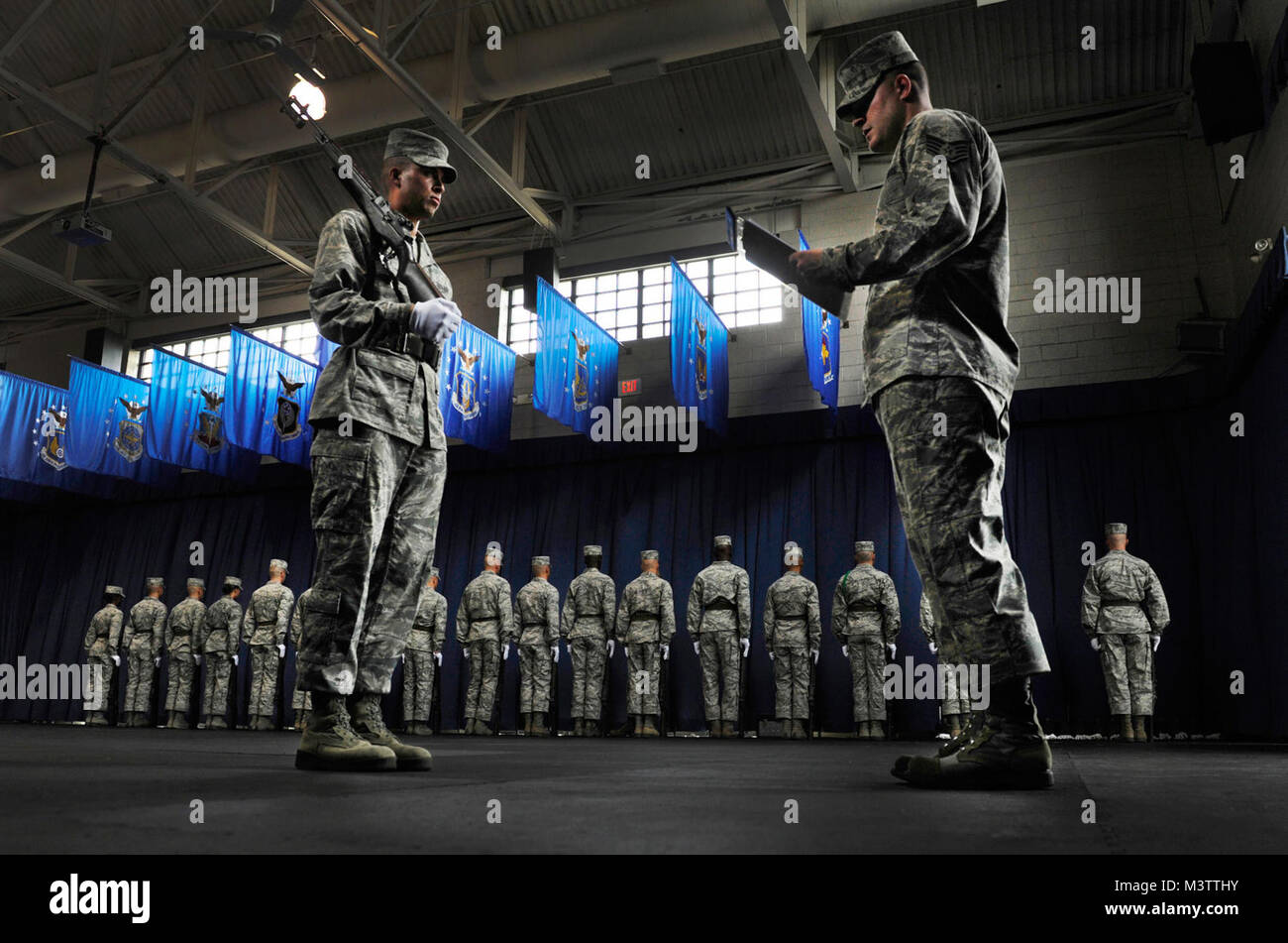 Airman Jason Ortega (left) holds his M14 rifle while Staff Sgt. Robert ...