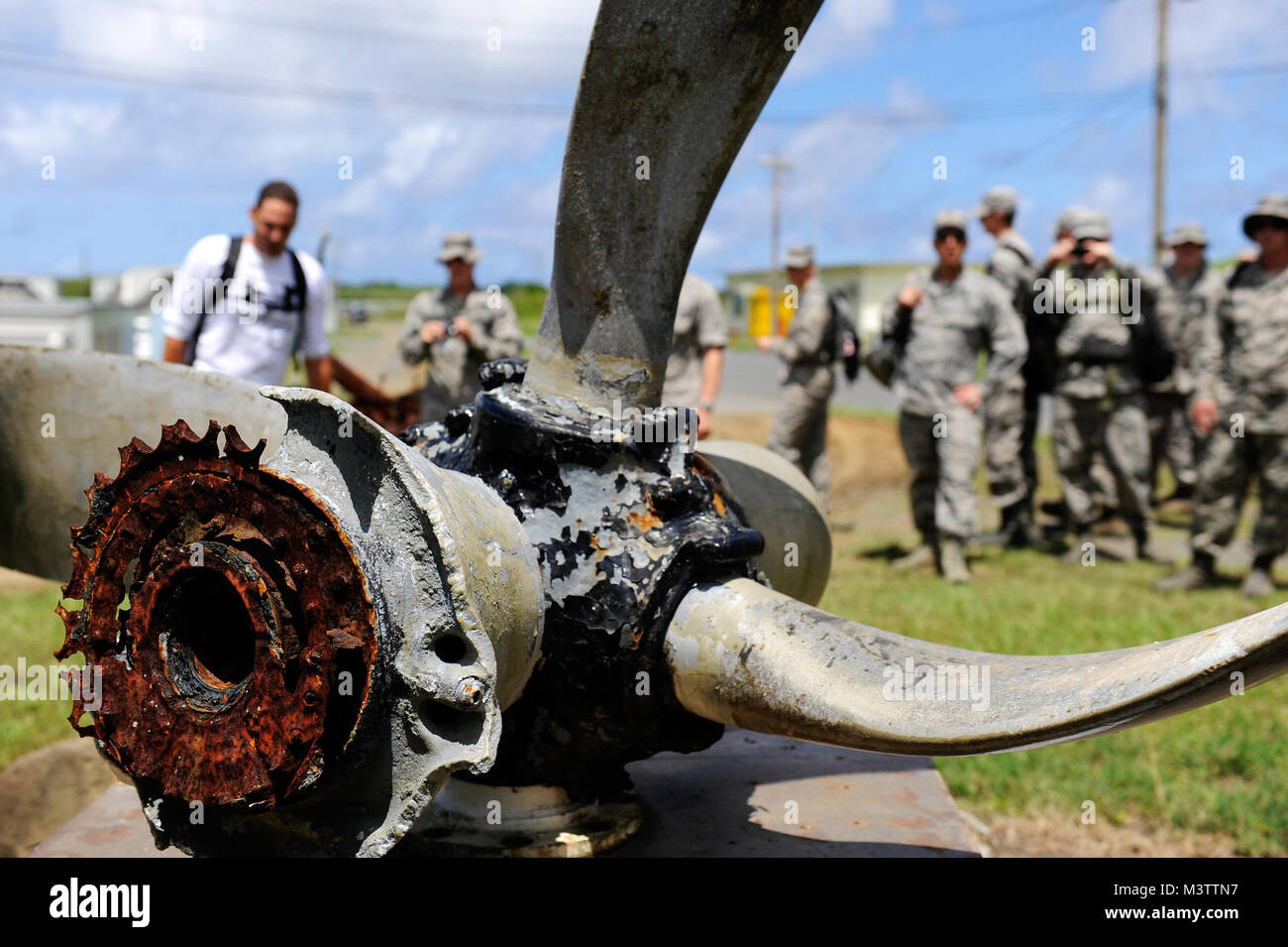 Airmen take photos of a destroyed B-29 Superfortress propeller. Members ...