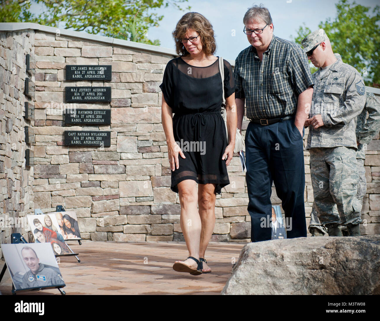 Family and friends look at plaques and photos of the nine fallen air ...