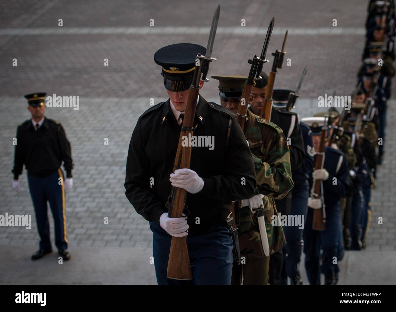 A joint service honor guard cordon march to position during the ...