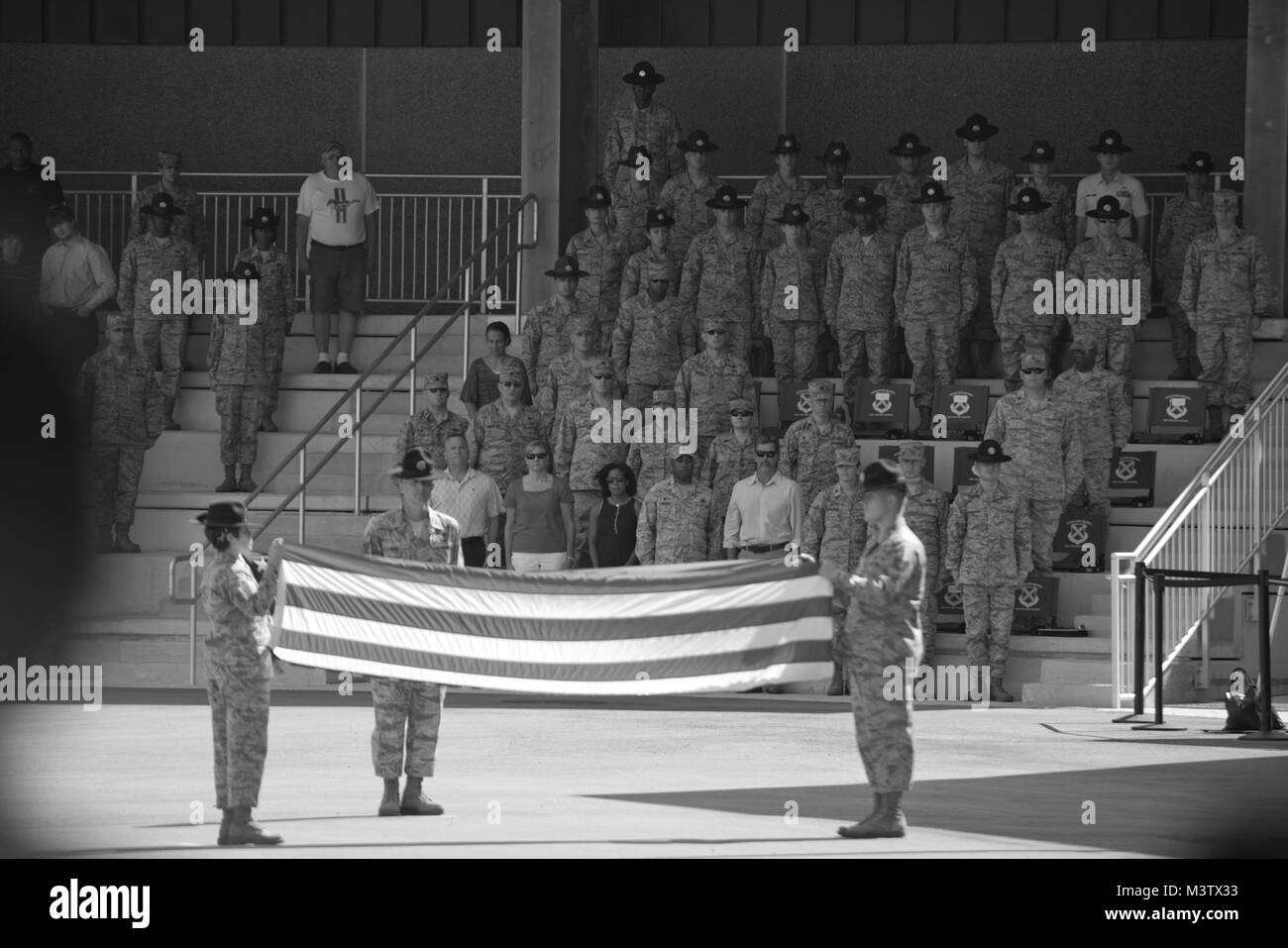 Military training instructors fold the American flag during the Airman ...