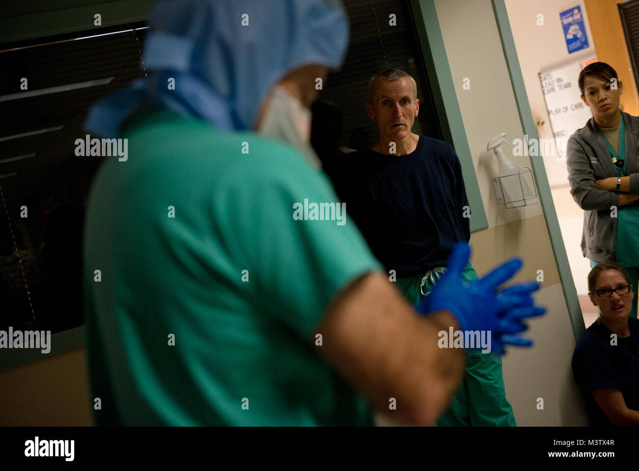 Col. (Dr.) Bradley Lloyd watches as Navy Cmdr. (Dr.) James Lawler ...