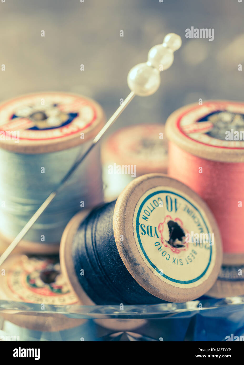 Collection of vintage sewing threads in glass tray Stock Photo - Alamy