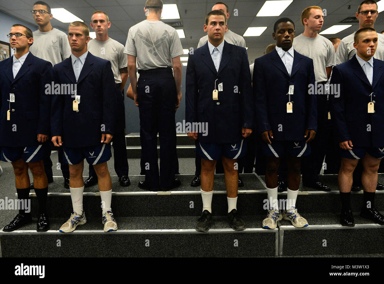 Trainees wait to be measured for their dress blues uniforms in their ...