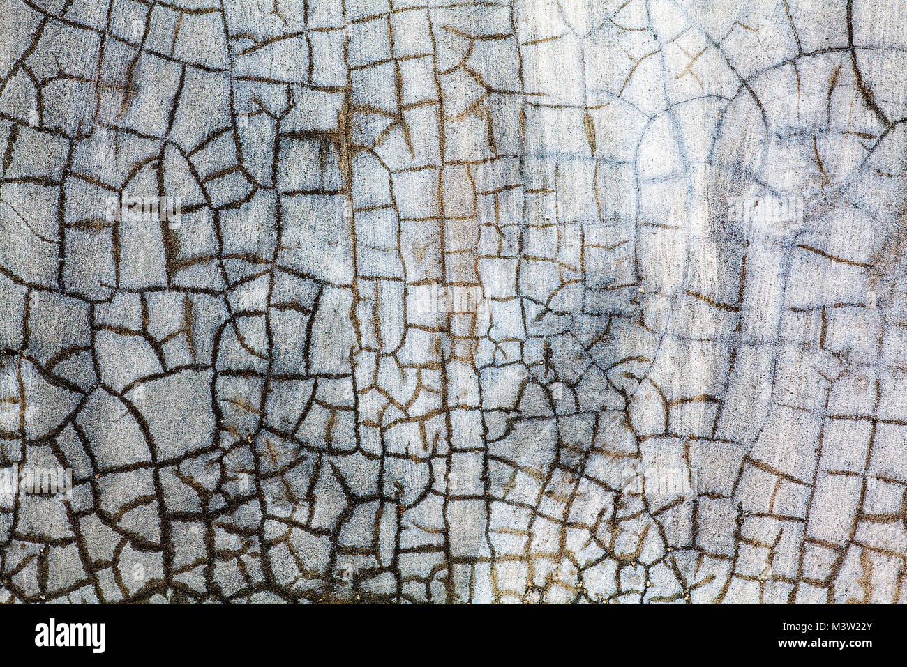 Crackled white paint on a concrete wall has a stained glass effect ...