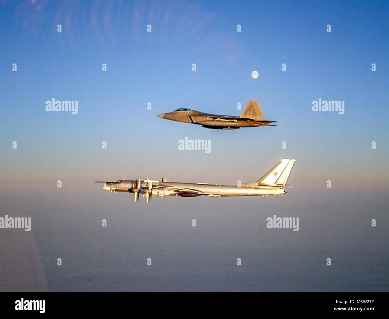A 90th Fighter Squadron F-22A Raptor escorts a Russian TU-95 Bear ...