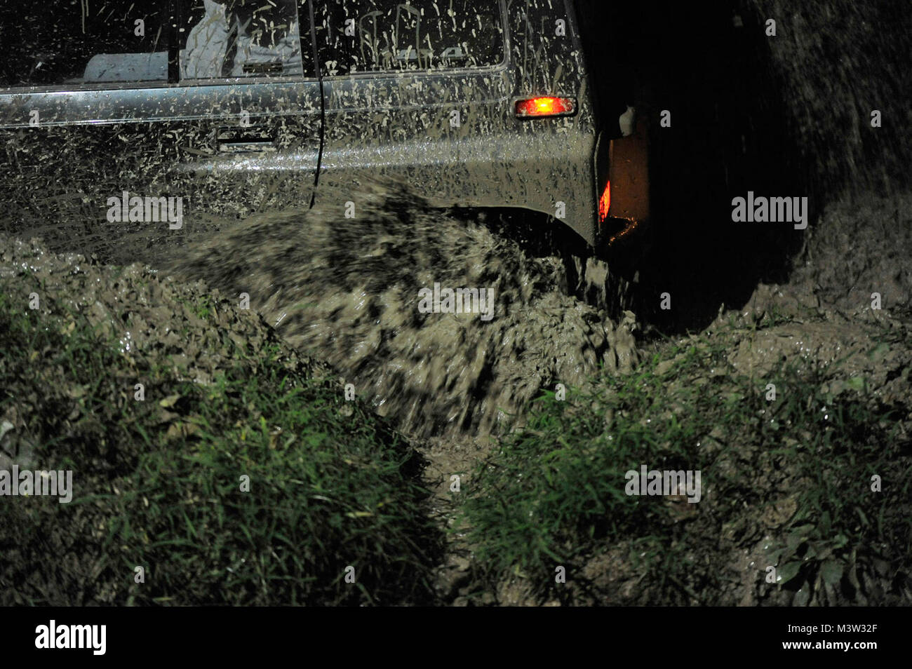 An off-roader tries to drive his vehicle out of a mud pit during a ...