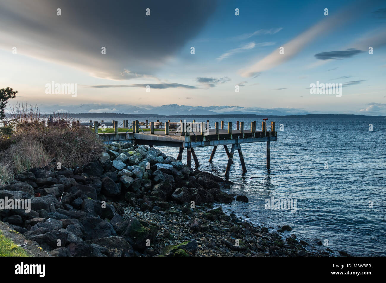 A view of a pier in West Seattle with the Olympic Mountains in the ...