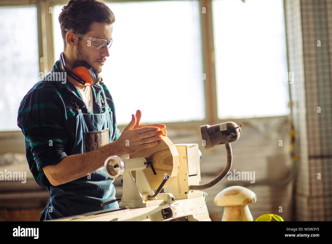 attractive man begin doing woodwork in carpentry Stock Photo - Alamy