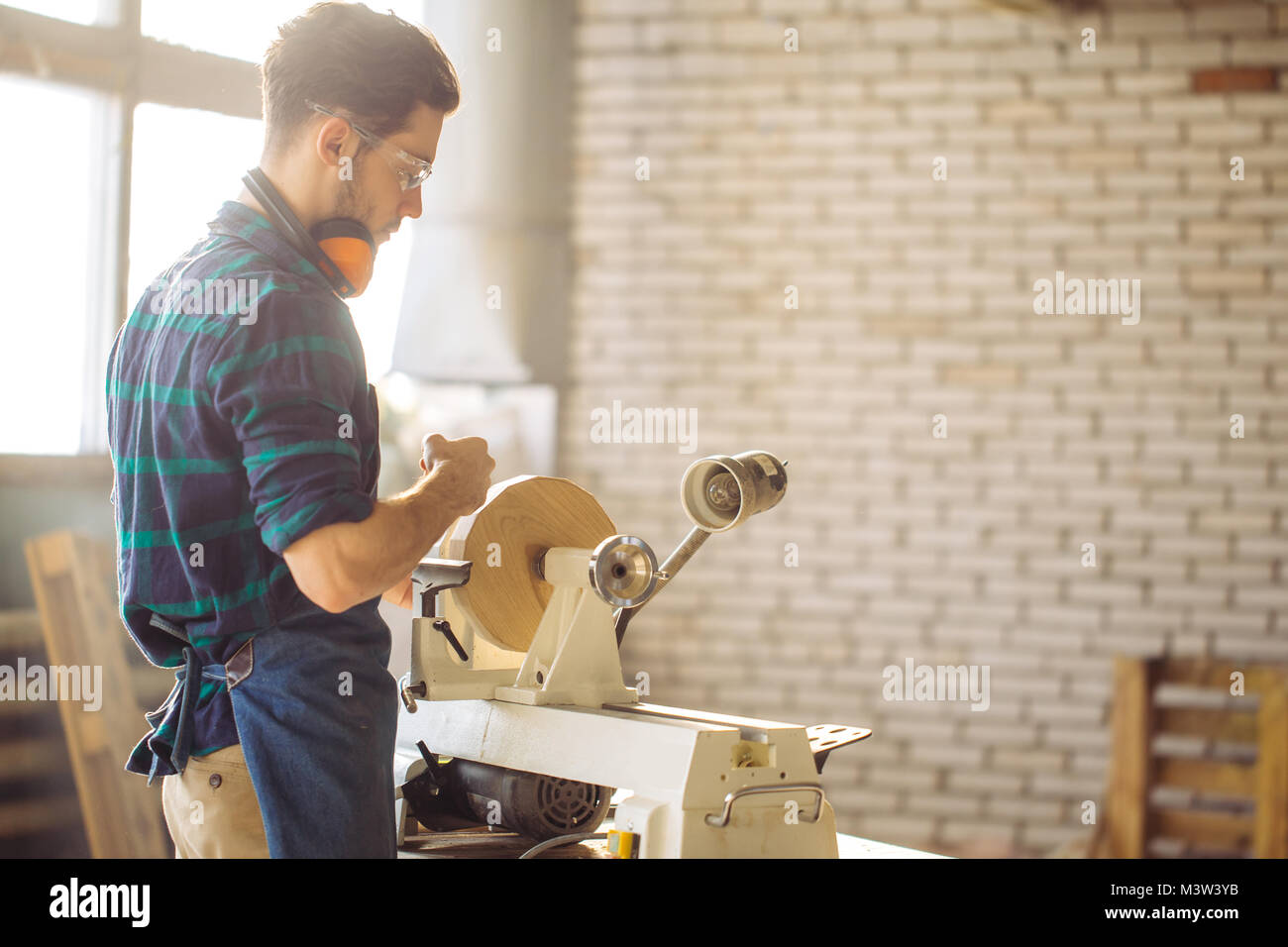 attractive man begin doing woodwork in carpentry Stock Photo - Alamy