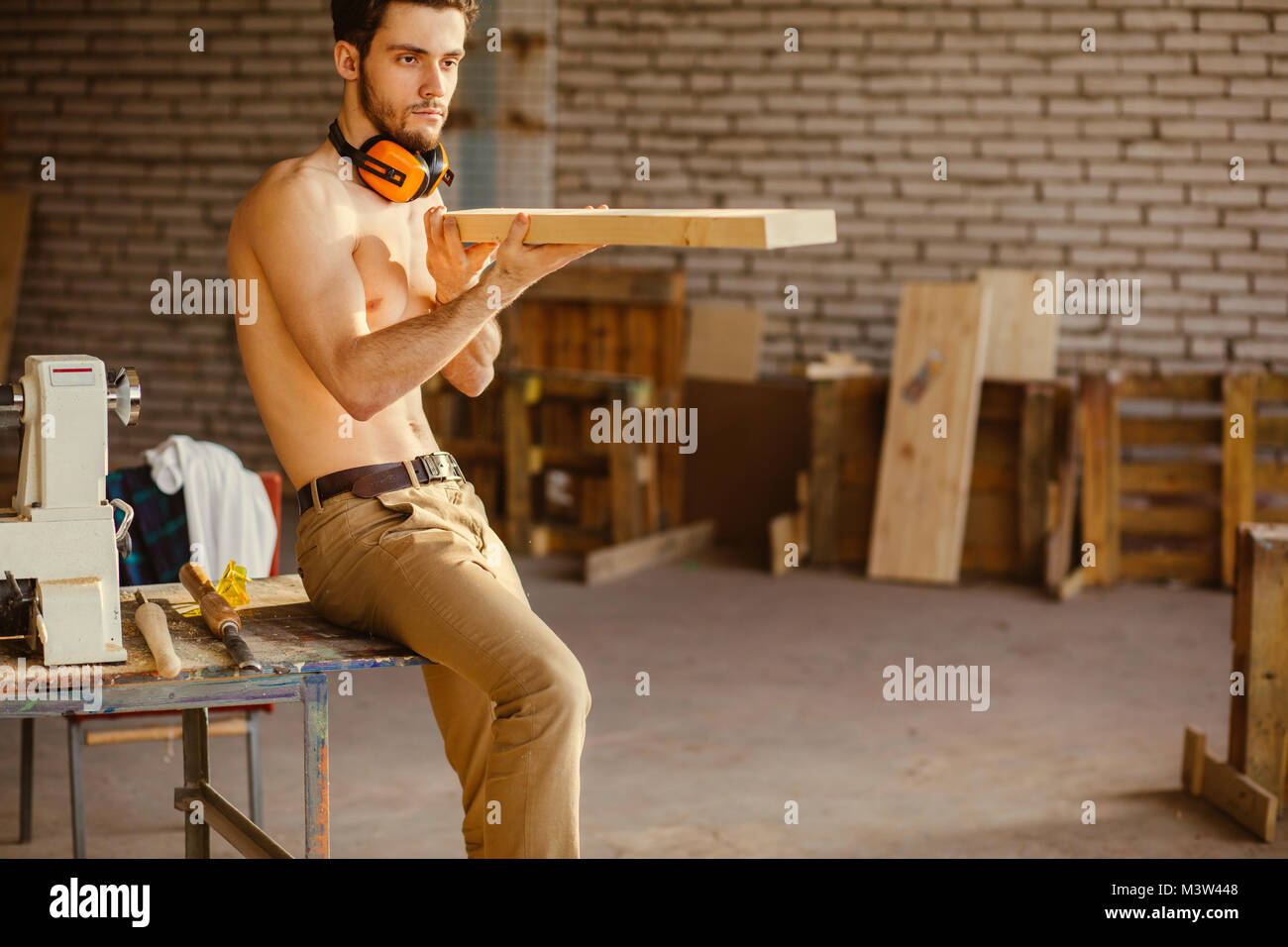 carpenter testing wood plank evenness at workshop Stock Photo - Alamy