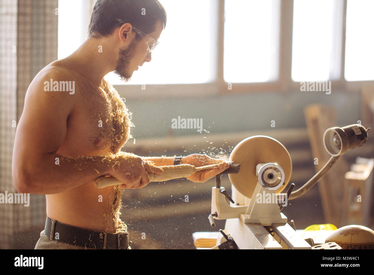 Wood lathe. Carpenter lathing wood Stock Photo - Alamy