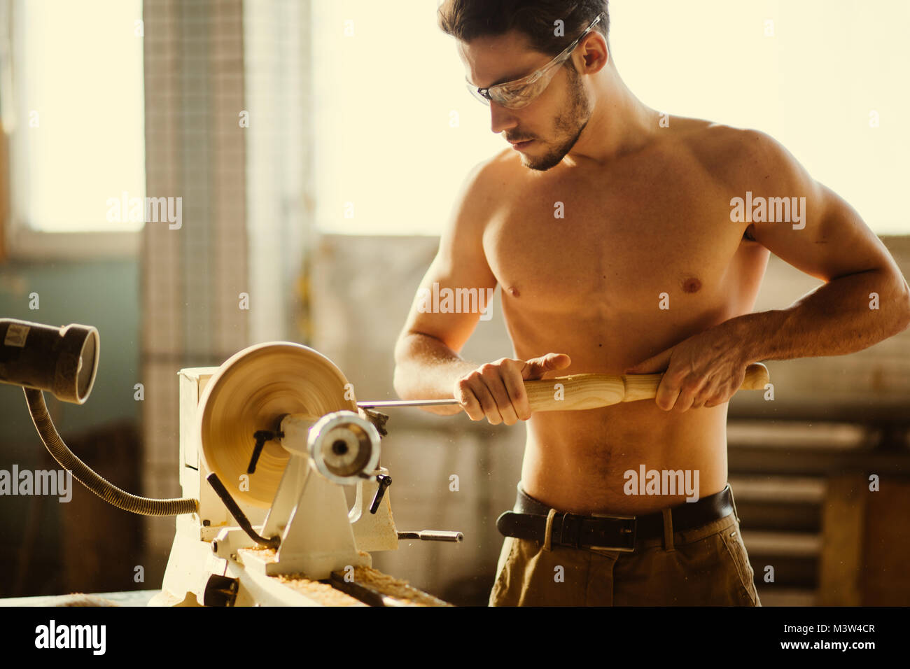 Wood lathe. Carpenter lathing wood Stock Photo - Alamy