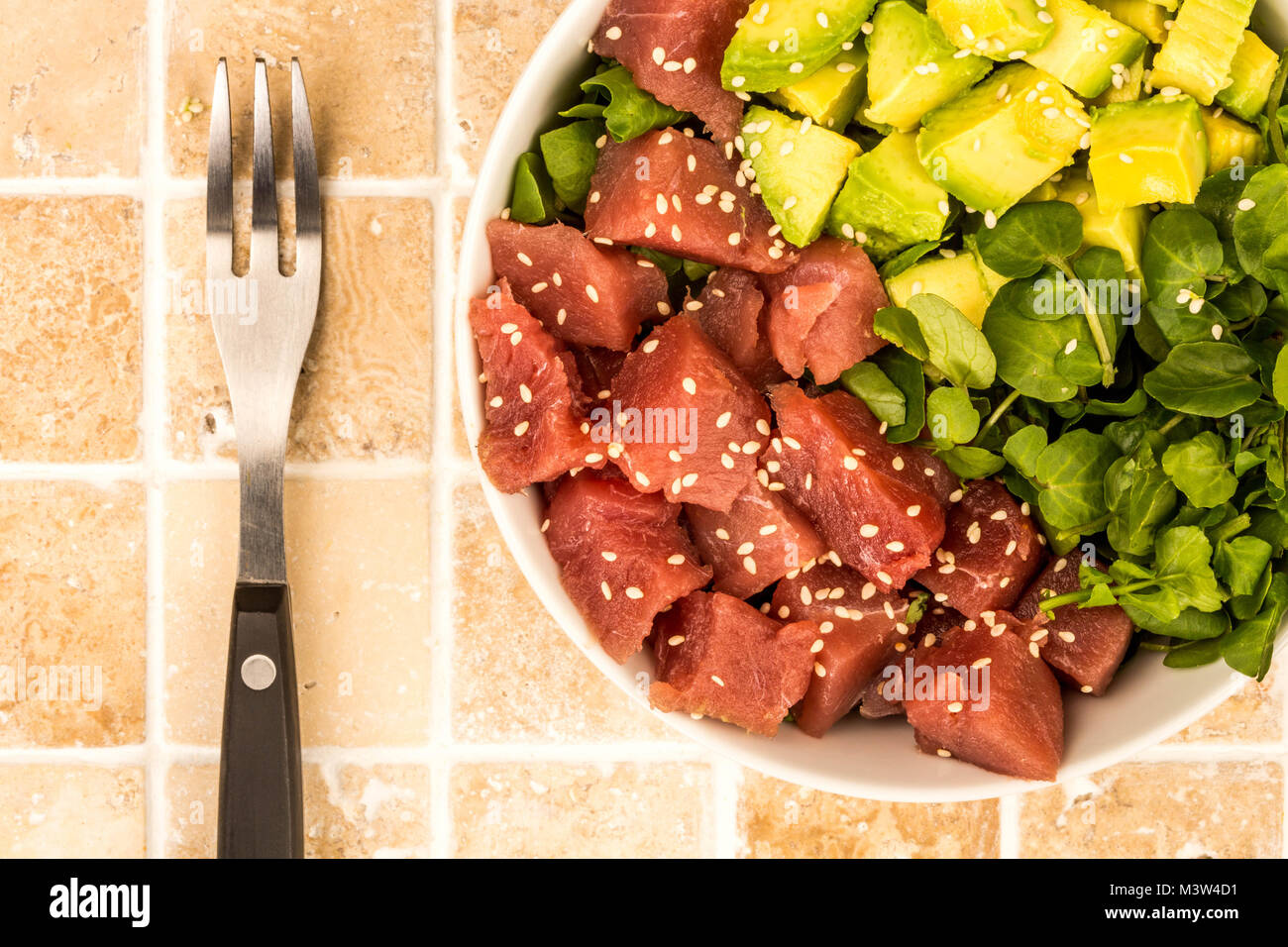 Hawaiian Style Tuna And Avocado Sashimi Poke Food Bowl Against A Tiled ...