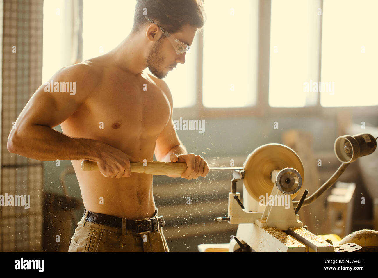 Wood lathe. Carpenter lathing wood Stock Photo - Alamy